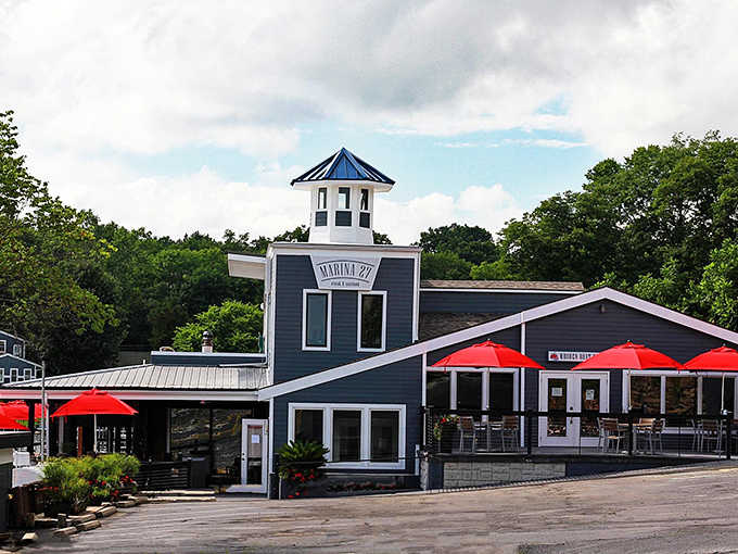 That blue and white exterior with the cheerful red umbrellas promises good times ahead on the water.