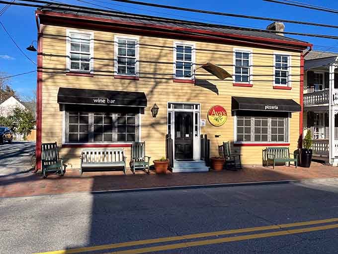 That yellow exterior with red trim isn't just charming—it's basically waving you down from the street.