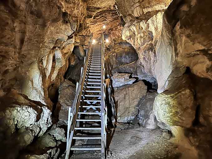 Metal stairs wind upward through ancient rock like a stairway built for geological time travelers with good knees.