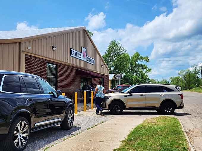 That brick facade might be humble, but the parking lot full of cars tells the real story here.