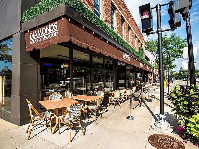 That elegant awning and those bistro chairs whisper Paris, but the steaks inside scream pure Michigan excellence.