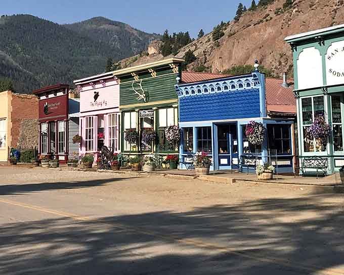 These candy-colored storefronts against towering peaks prove that Victorian miners had better taste than most modern architects.