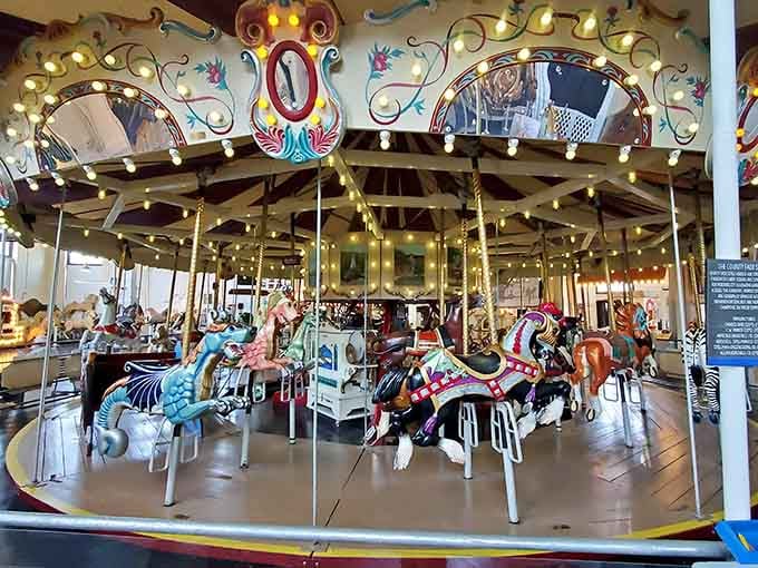 Hand-carved horses frozen mid-gallop, waiting patiently for their next adventure around the ring.