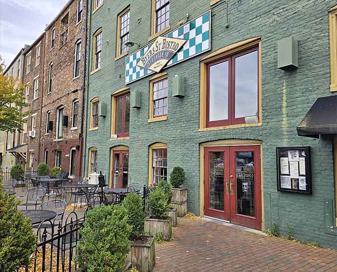 That green facade with red trim isn't just pretty, it's basically a beacon calling you to pizza paradise.