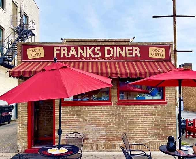 The vintage signage glowing against the blue sky makes this lunch car look like the star of its own classic diner movie.