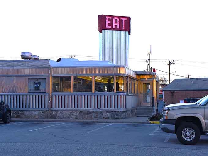 That gleaming stainless steel exterior isn't trying to look vintage, it just is, complete with neon promises.