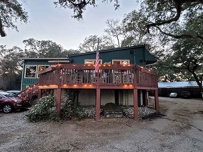 The charming exterior with its lattice work and elevated deck promises the waterfront dining experience that awaits inside and out.