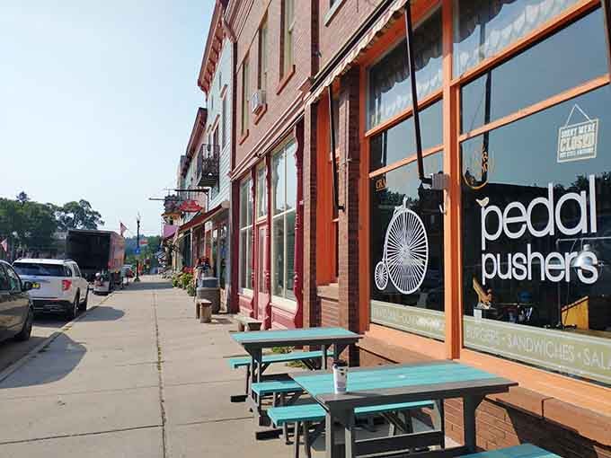 That cheerful turquoise seating outside Pedal Pushers is calling your name louder than your morning alarm ever could.