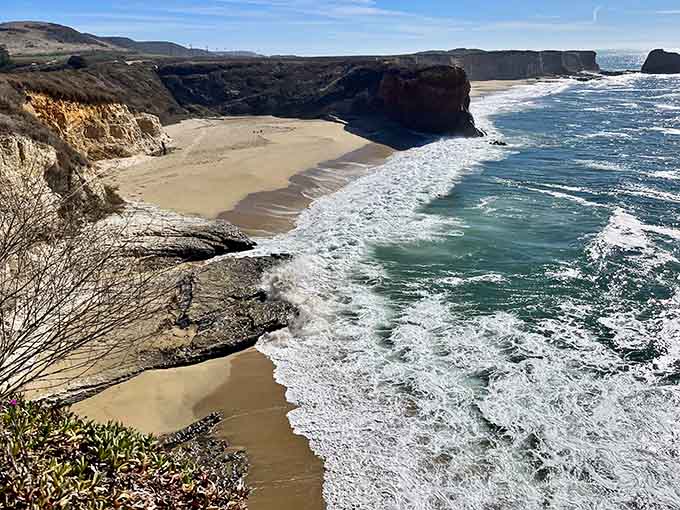 That crescent of golden sand tucked between dramatic cliffs looks like nature's own private VIP section.