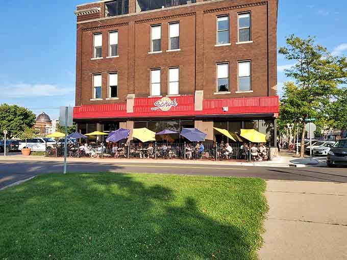 Those colorful umbrellas aren't just pretty; they're your shield against the sun while you tackle a serious burger.