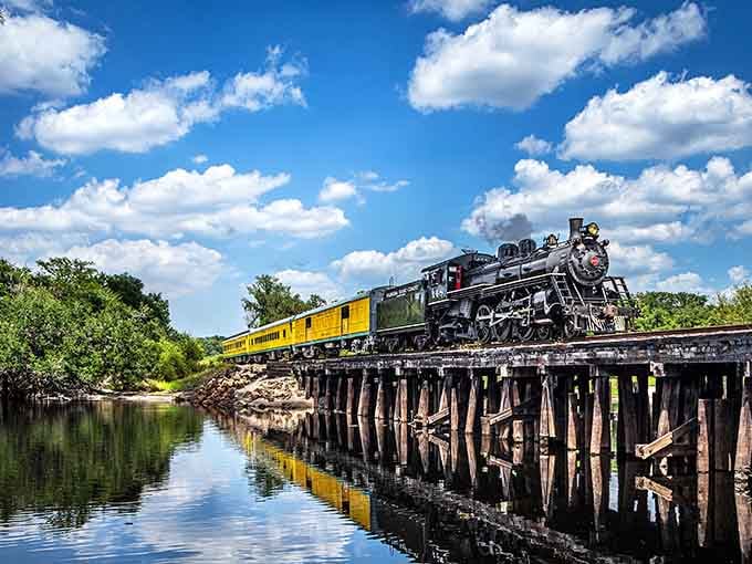 When a steam locomotive crosses a wooden trestle bridge, you're witnessing pure Florida magic in motion.