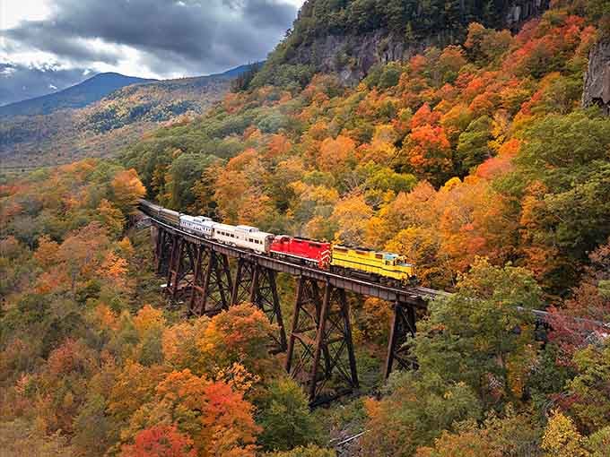 The Blue Ridge Scenic Railway winding through fall's explosive color palette looks like nature showing off shamelessly.