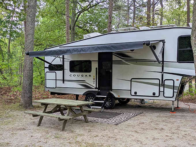 RV camping with all the comforts of home, including that outdoor rug that somehow makes everything feel more civilized.