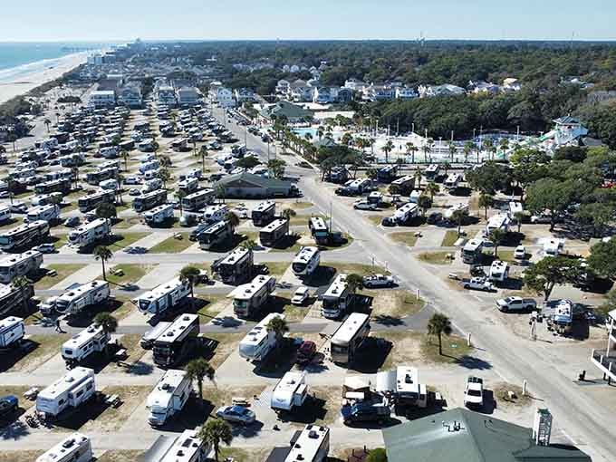 Rows of RVs create their own neighborhood where everyone's a temporary local living their best coastal life.