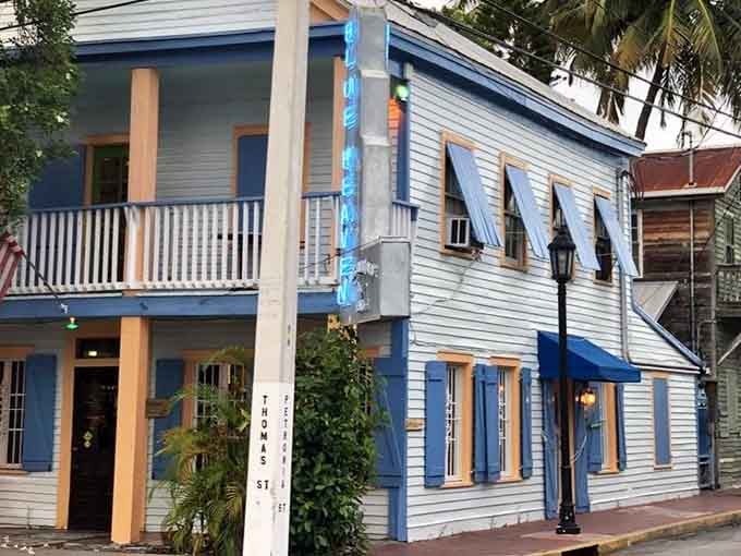 That weathered blue exterior isn't just paint, it's decades of stories soaking into every sun-bleached board.