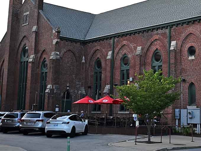 The outdoor patio with those cheerful red umbrellas is where history meets happy hour, and honestly, they get along surprisingly well together.