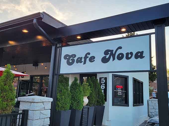 That retro script signage glowing at dusk promises Mediterranean magic, and those string lights aren't lying about it.