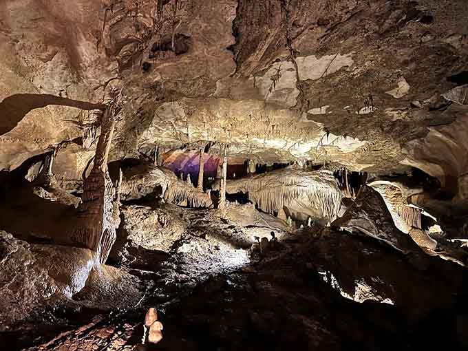 Flowstone formations cascade down like frozen waterfalls, creating sculptures that belong in a geological art museum.