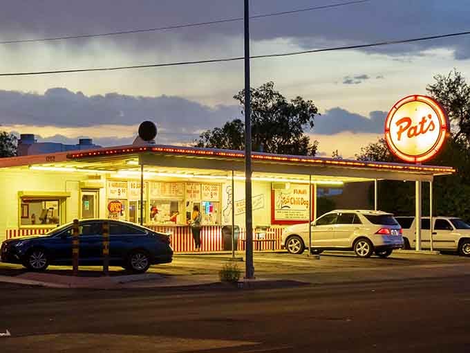 That glowing sign at dusk isn't just advertising, it's a beacon calling you home to chili dog heaven.