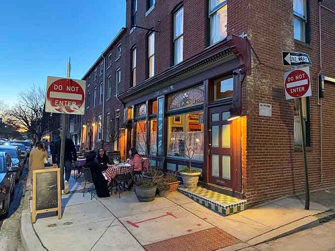 That golden glow spilling from the windows at dusk tells you everything: something magical is happening inside this corner rowhouse.