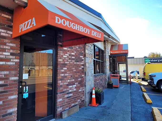 The brick facade and bright orange awning practically shout "donuts inside" louder than a town crier.