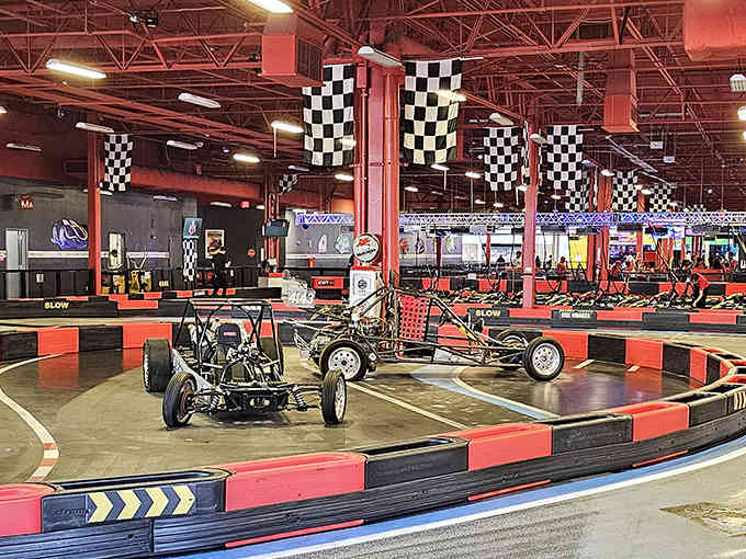 Behind those checkered banners lies a go-kart track where responsible adults temporarily forget they own minivans.