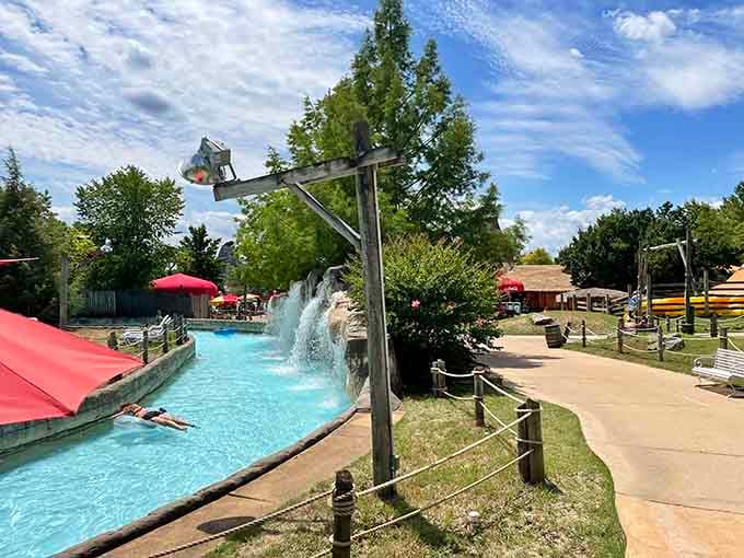 The lazy river winds past waterfalls and under bridges, proving that sometimes the best adventures involve doing absolutely nothing.