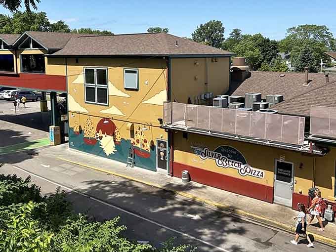 That yellow exterior isn't just cheerful &ndash; it's a beacon guiding hungry souls to pizza paradise by the lake.