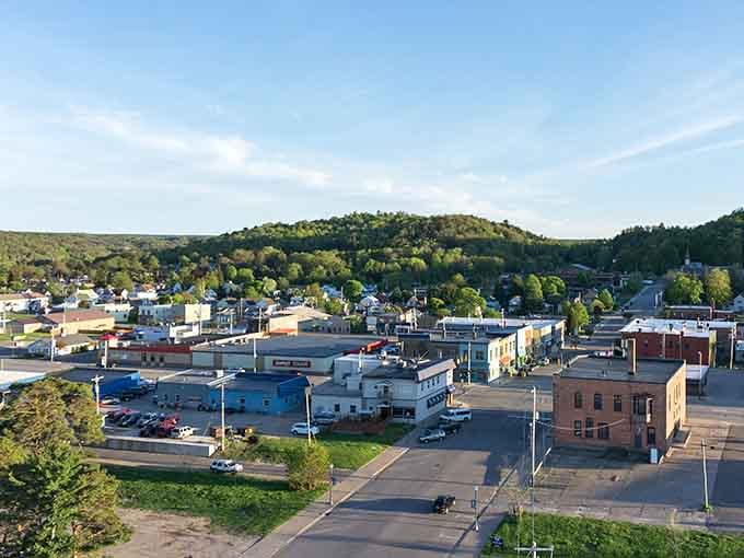 The aerial view reveals a town nestled between forest and lake, proving paradise doesn't require skyscrapers.