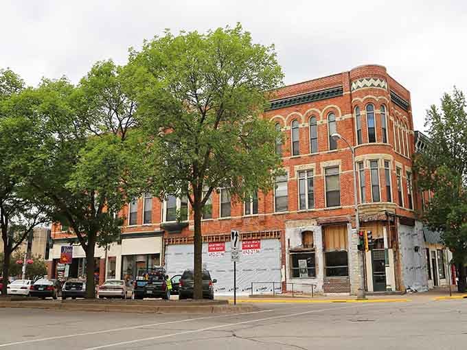 Victorian brick buildings framed by leafy trees prove that downtown architecture peaked somewhere around 1890 and never looked back.