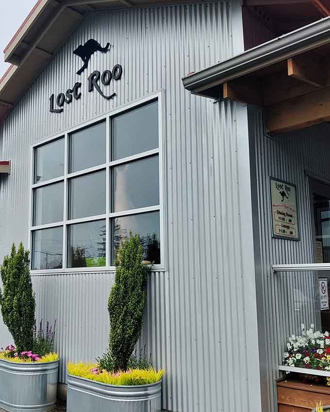 Modern coastal architecture meets playful charm where corrugated metal and fresh landscaping create an inviting entrance.