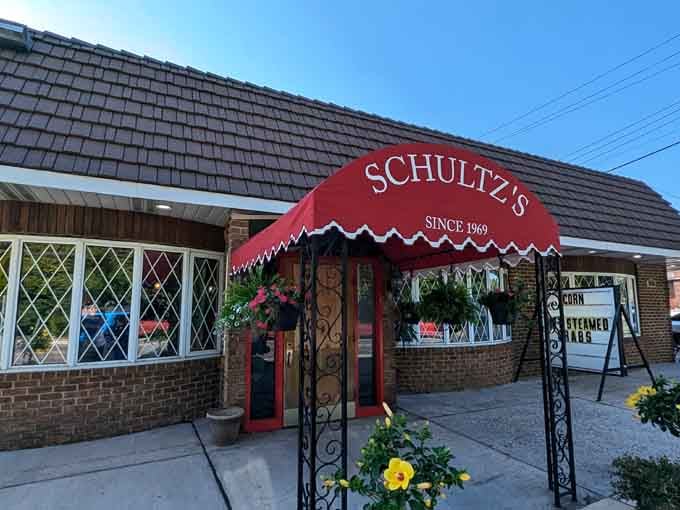 More blooms frame the entrance, proving even the most authentic crab houses can have a soft spot for beauty.