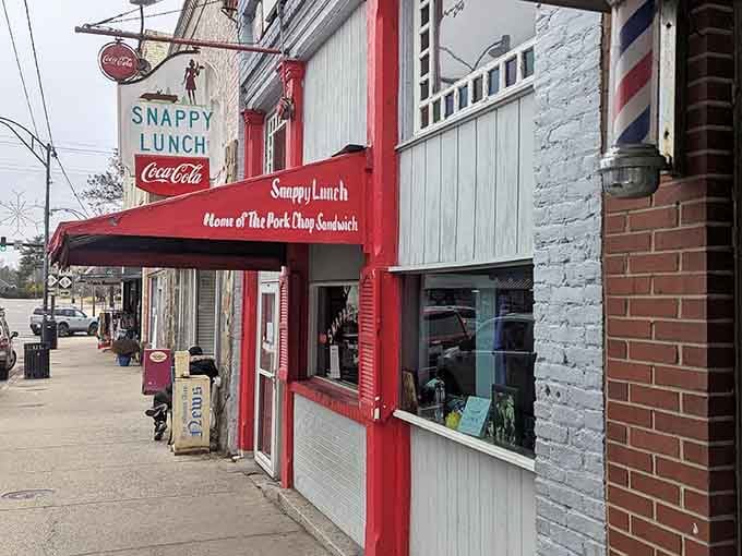 That red and white striped awning isn't just charming, it's been beckoning hungry souls for generations.