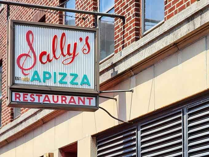 That iconic red script glowing is your beacon to pizza paradise on Wooster Street.
