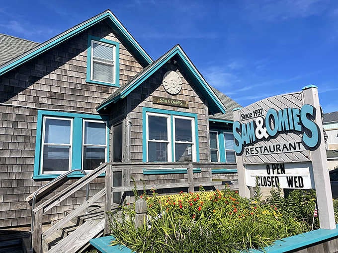 Sam & Omie's exterior showing its proud turquoise accents, a beacon for hungry souls seeking authentic coastal cooking.