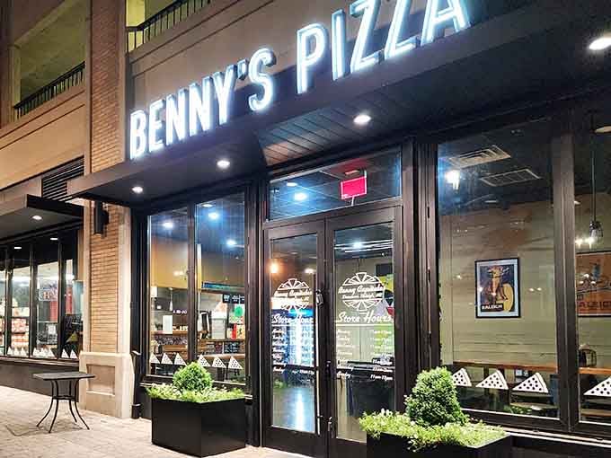 That storefront glow means one thing: pizza paradise awaits inside, and it's bigger than you ever imagined.