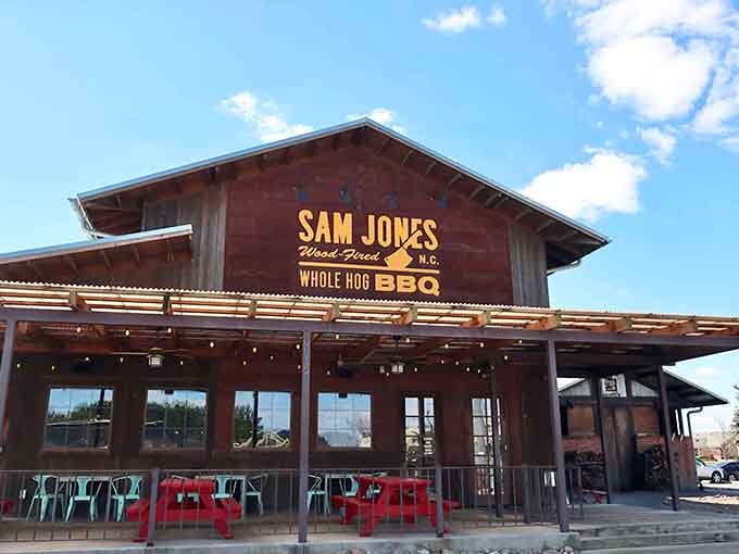 The rustic barn-style building promises serious barbecue business, where wood smoke and tradition meet under Carolina skies.