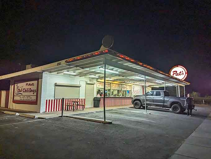 That glowing sign at dusk isn't just advertising, it's a beacon calling you home to chili dog heaven.