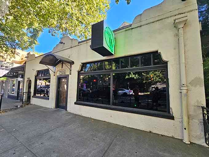 That glowing green bird sign is your beacon to paradise, calling you off Sacramento's streets into tropical bliss.