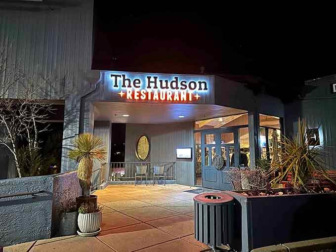 The Hudson's glowing sign beckons like a lighthouse for the hungry, promising comfort food and good times ahead.
