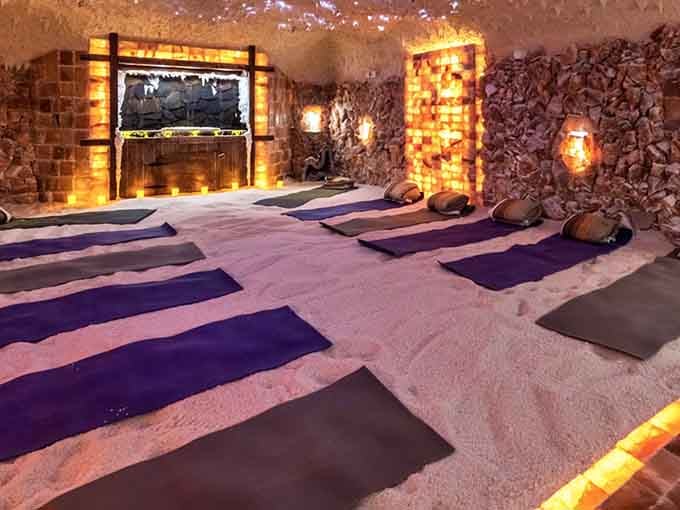Step inside this glowing sanctuary where salt-covered walls create an atmosphere that's pure therapeutic magic.