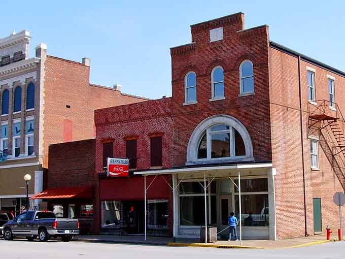 Brick buildings with arched windows stand as testament to craftsmanship that makes modern construction look embarrassingly flimsy.