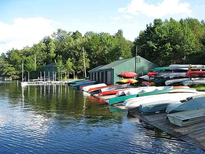 Rainbow canoes lined up like a paint store exploded in the best possible way&mdash;your lake adventure awaits.