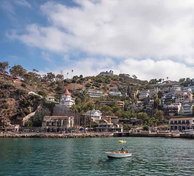 That crescent bay cradles boats like precious gems, proving Mother Nature has excellent taste in harbor design and color palettes.