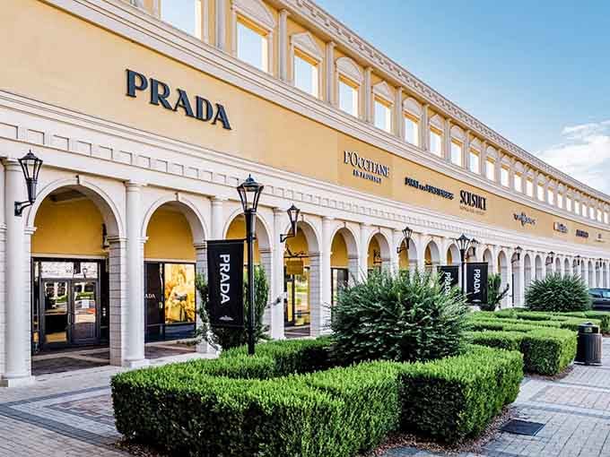 Prada's elegant arches and manicured landscaping create an Italian plaza vibe, making luxury shopping feel like a European vacation without the jet lag.