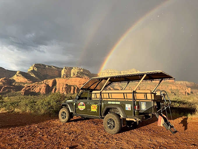 When Mother Nature decides to show off with a rainbow over red rocks, even the Jeep stops to admire.