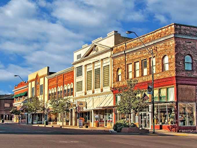 Golden hour kisses these historic storefronts, each one hiding delicious secrets behind weathered brick and arched windows.