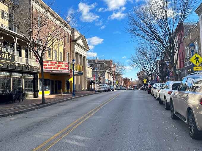 A charming Main Street where bare winter trees frame historic storefronts and the promise of small-town discoveries awaits.