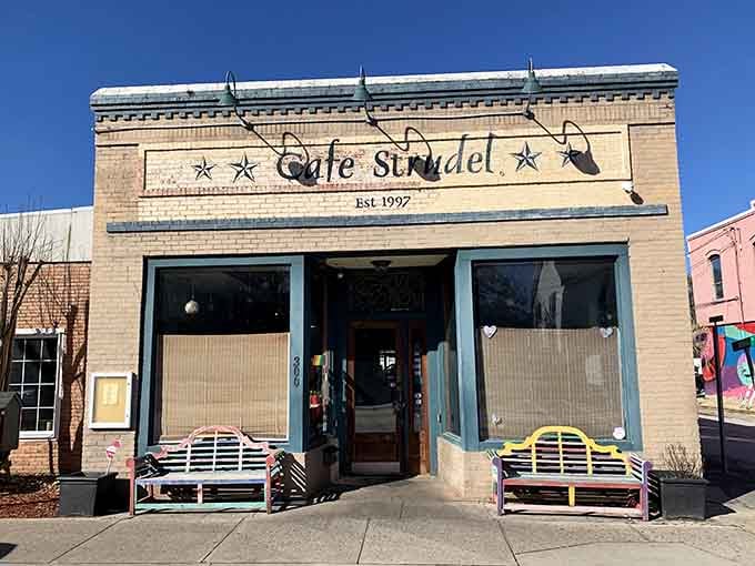 That charming storefront with the colorful benches is your gateway to breakfast bliss in West Columbia.