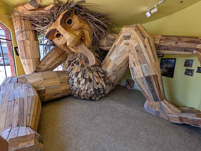 This magnificent wooden giant fills the entire gallery space with reclaimed lumber and pure imagination.